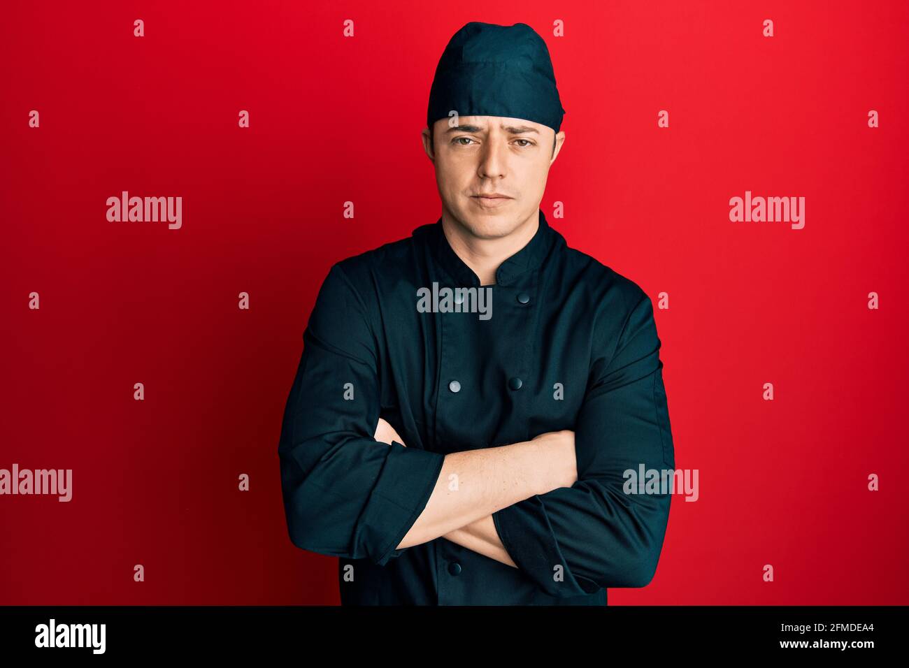 Serious male cook arms crossed hi-res stock photography and images - Alamy