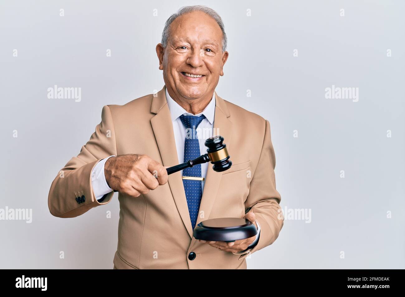 Senior caucasian judge man using gavel smiling with a happy and cool ...