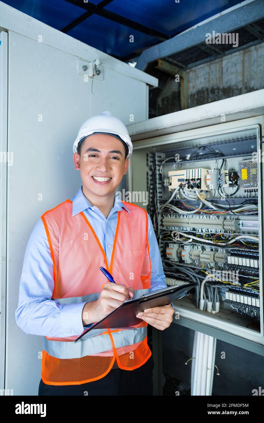 Asian Indonesian Technician or electrician making function test on ...