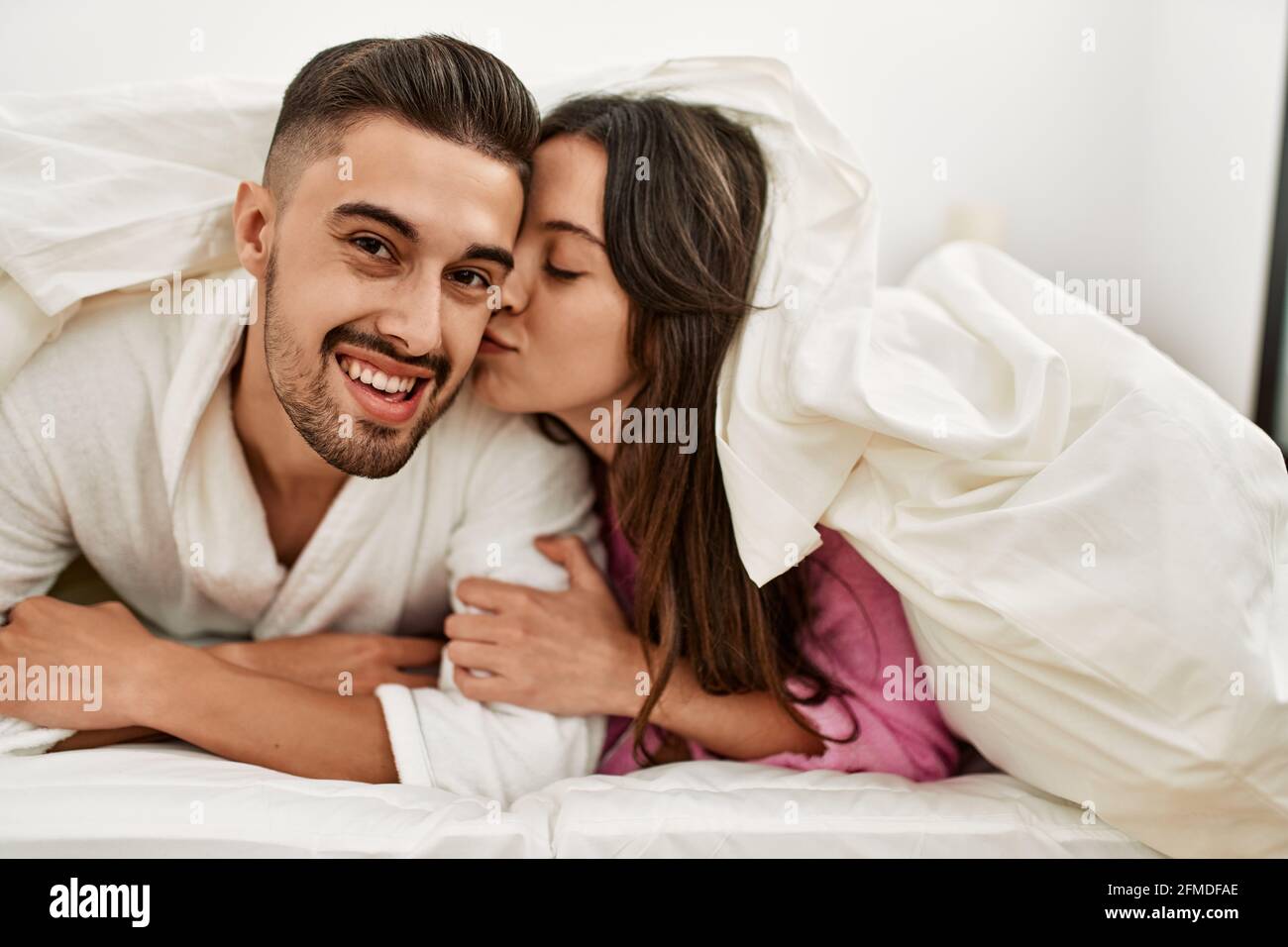 Relaxed couple kissing in bed hi-res stock photography and images - Alamy