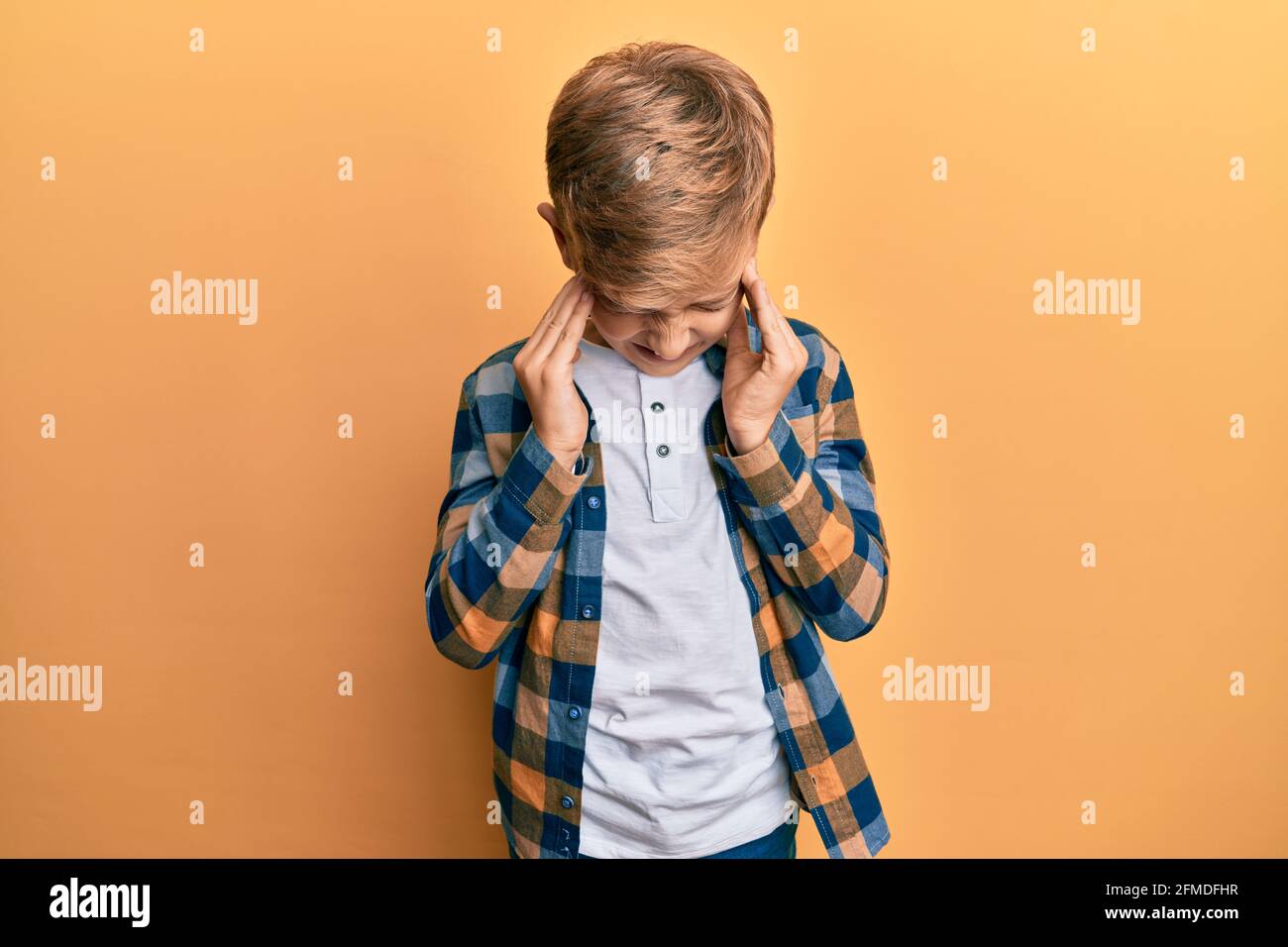 Little caucasian boy kid wearing casual clothes suffering from headache ...