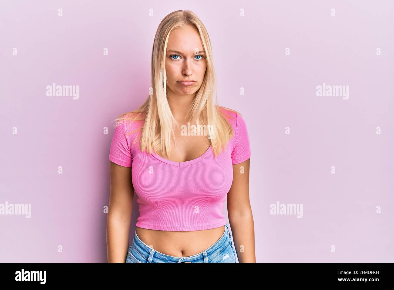 Young blonde girl wearing casual clothes depressed and worry for ...