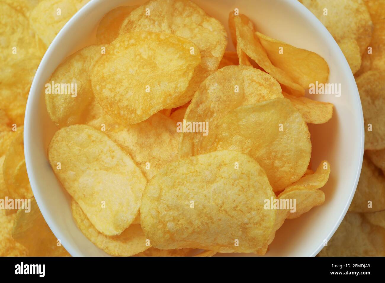 Bowl with tasty potato chips, top view Stock Photo - Alamy
