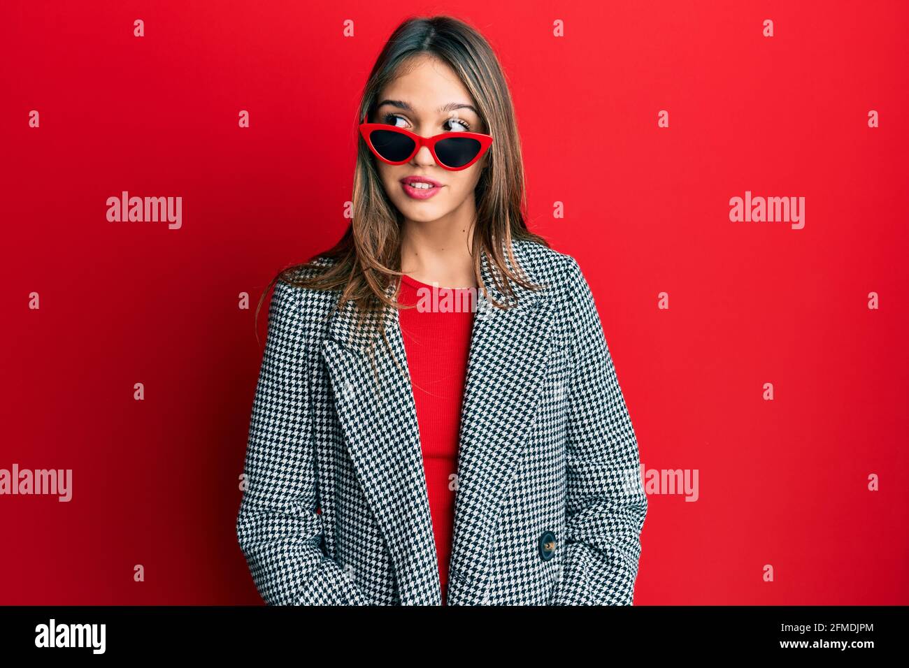 Young brunette woman wearing fashion and modern look smiling looking to ...