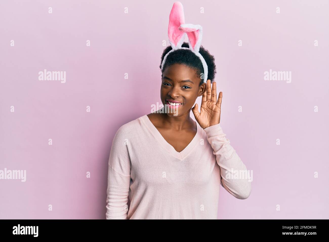 Young african american girl wearing cute easter bunny ears smiling with ...