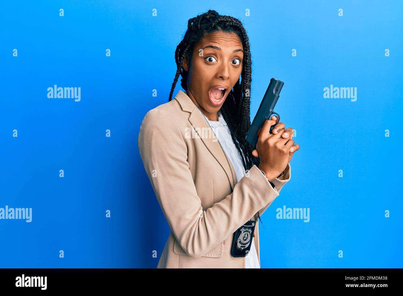 African American Police Woman Holding Gun Celebrating Crazy And Amazed