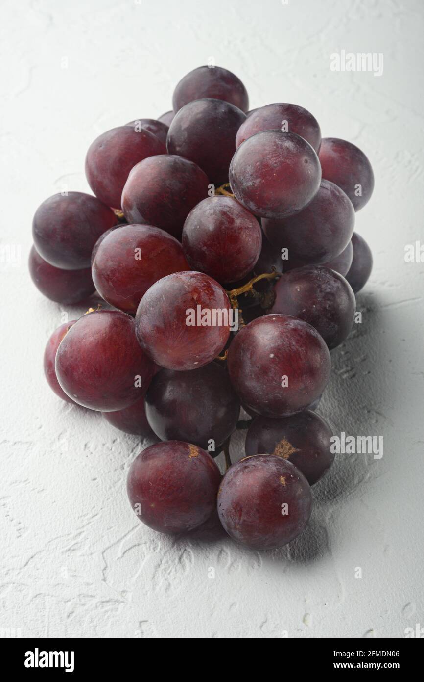 Red and white grapes set, dark red fruits, on white stone background ...