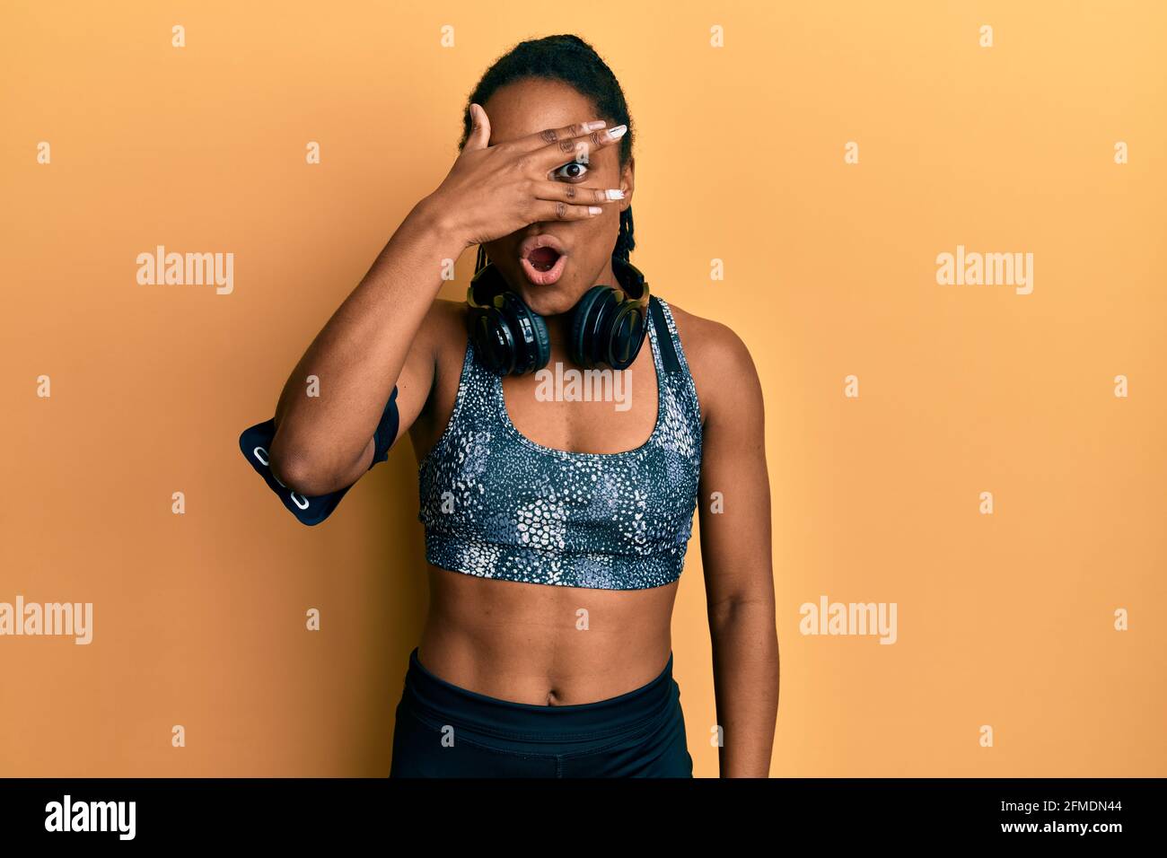 African american woman with braided hair wearing sportswear and arm ...