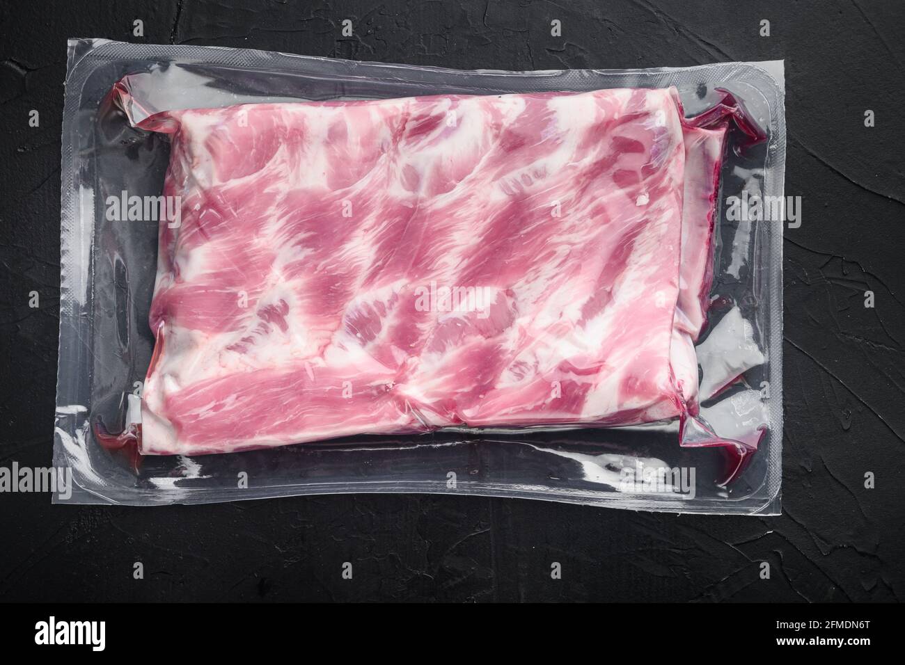 Fresh Pork rib in plastic pack set, on black stone background, top view ...