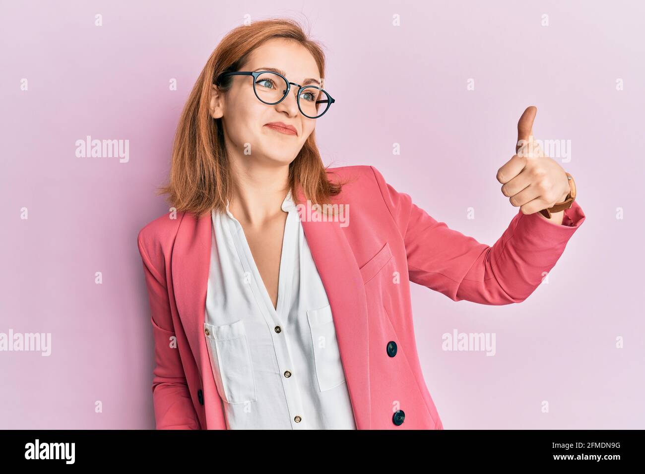 Young caucasian woman wearing business style and glasses looking proud ...