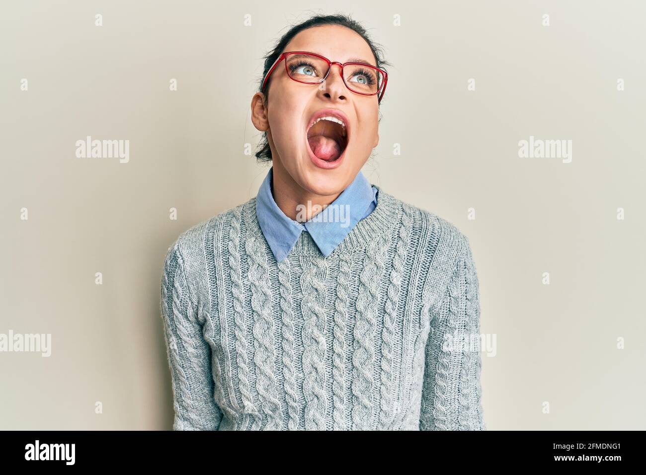 Young caucasian woman wearing casual clothes and glasses angry and mad ...