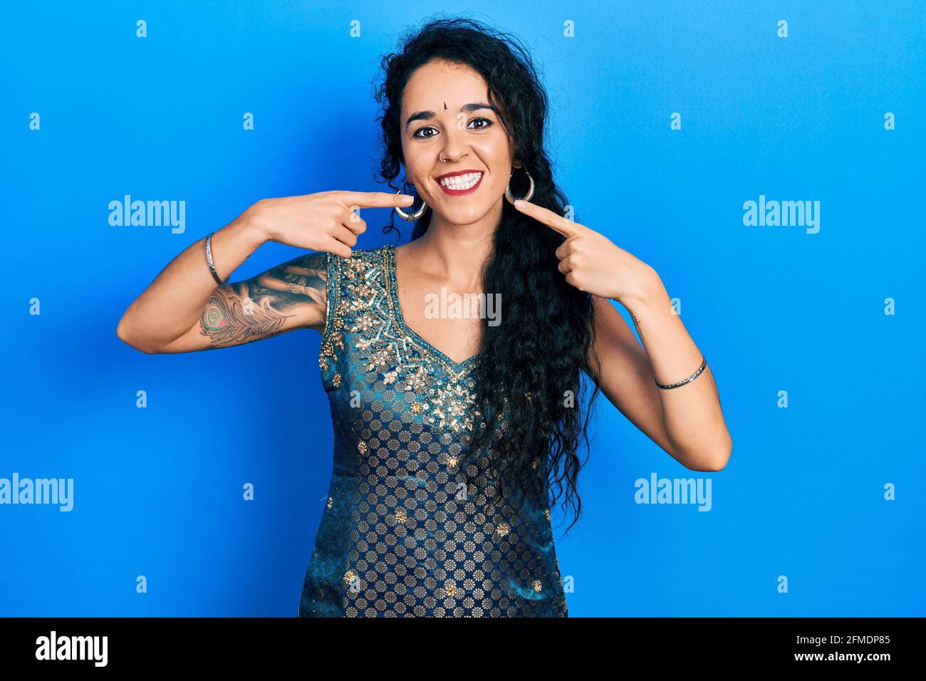 Young woman wearing bindi and traditional kurta dress smiling cheerful ...