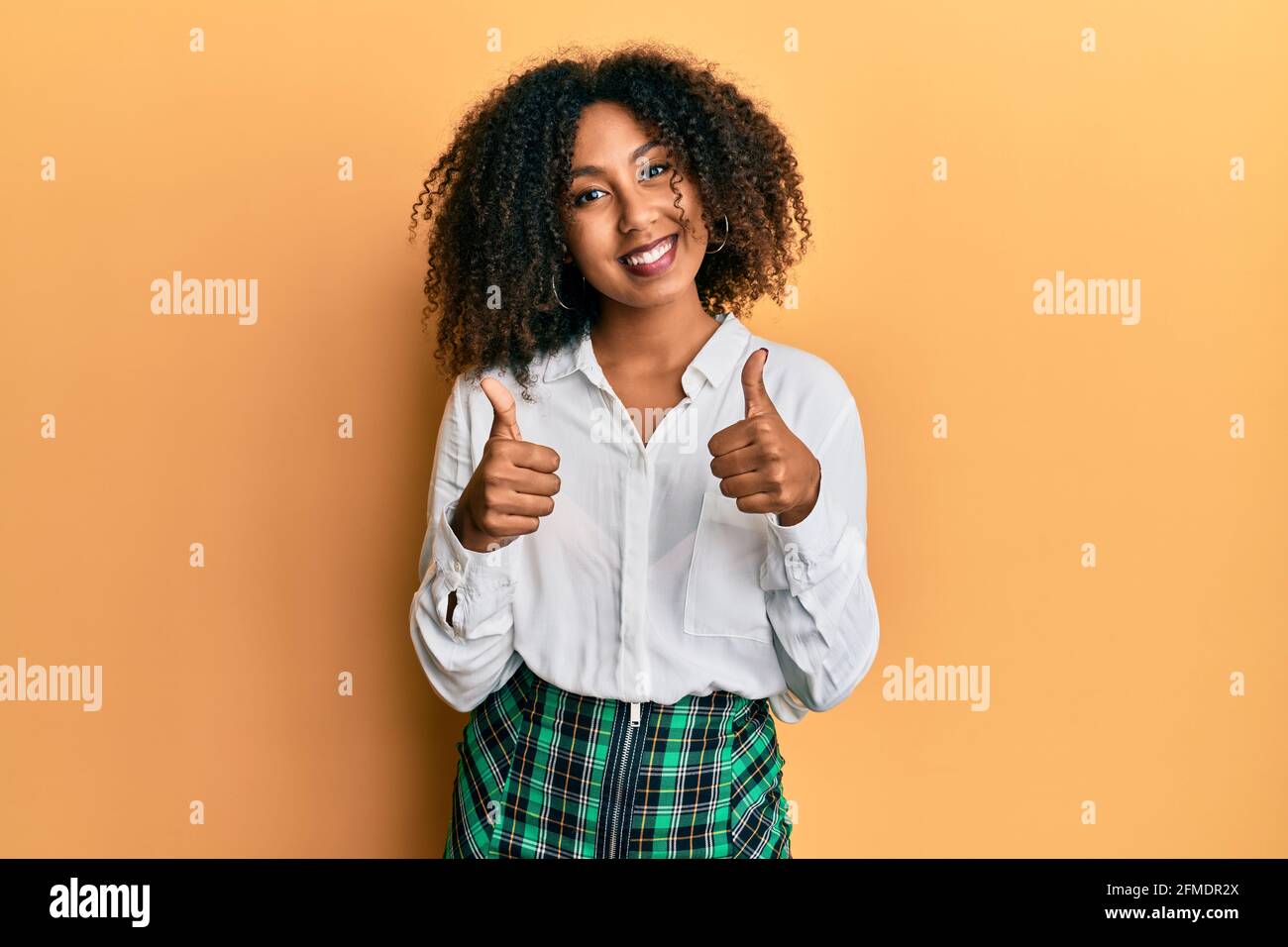 Beautiful african american woman with afro hair wearing scholar skirt ...