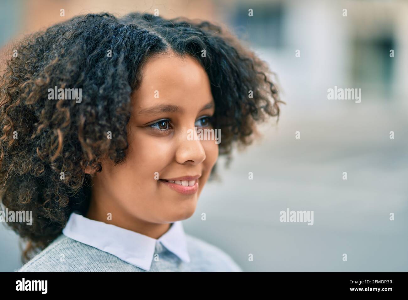 Adorable hispanic child girl smiling happy standing at the city Stock ...