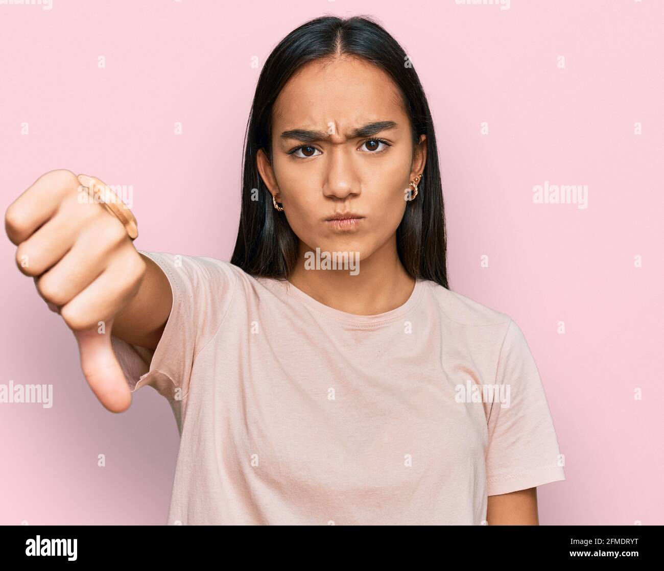 Young asian woman wearing casual clothes looking unhappy and angry ...