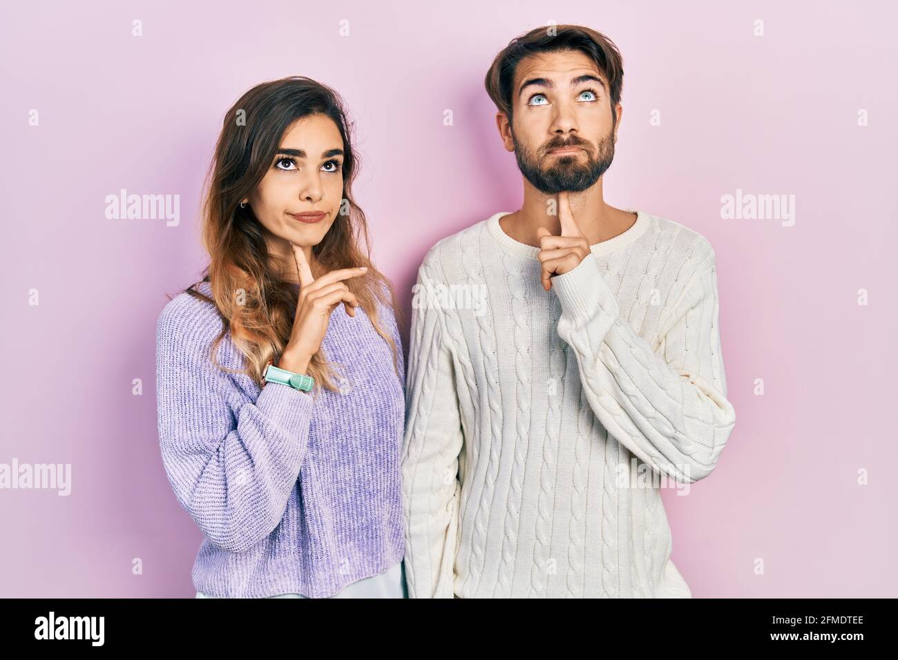 Young hispanic couple wearing casual clothes thinking concentrated ...