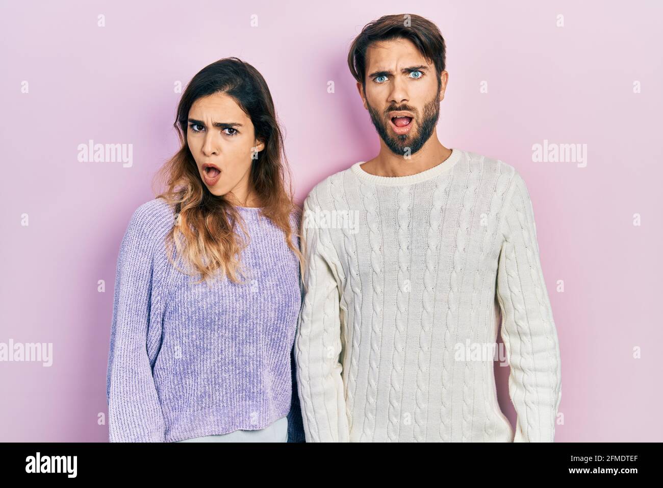 Young hispanic couple wearing casual clothes in shock face, looking ...