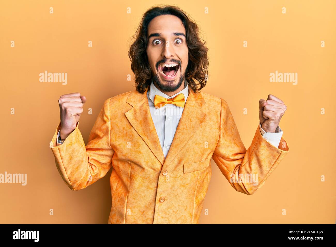 Young hispanic man wearing hipster elegant look celebrating surprised ...