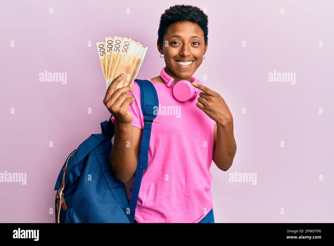 Young african american girl wearing student backpack holding norwegian ...