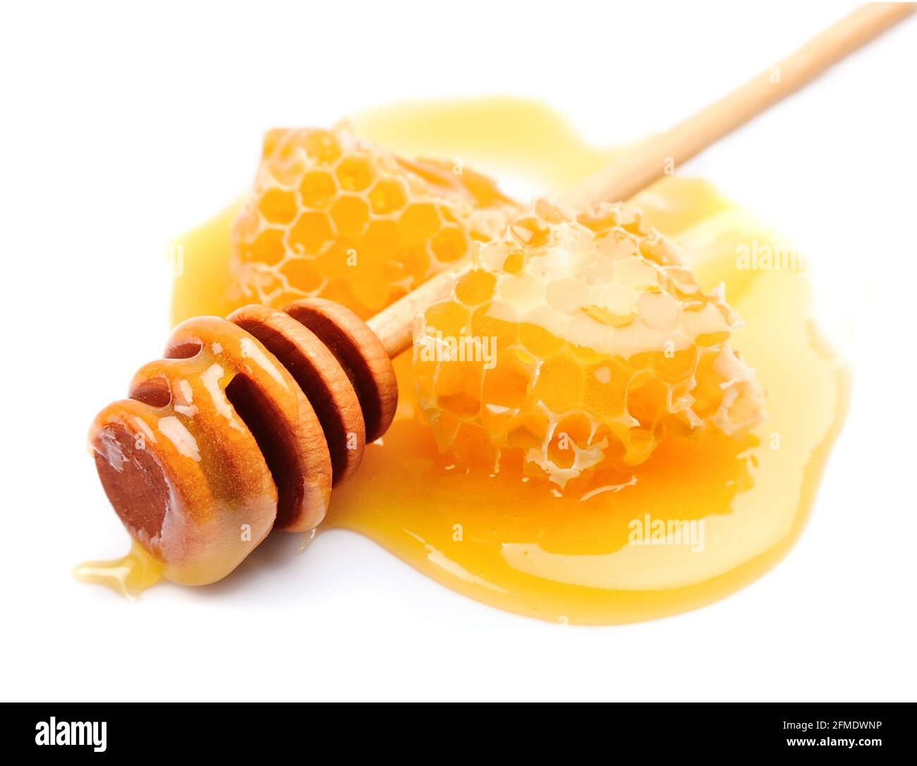 Honey dipper with honeycomb close up on white Stock Photo - Alamy