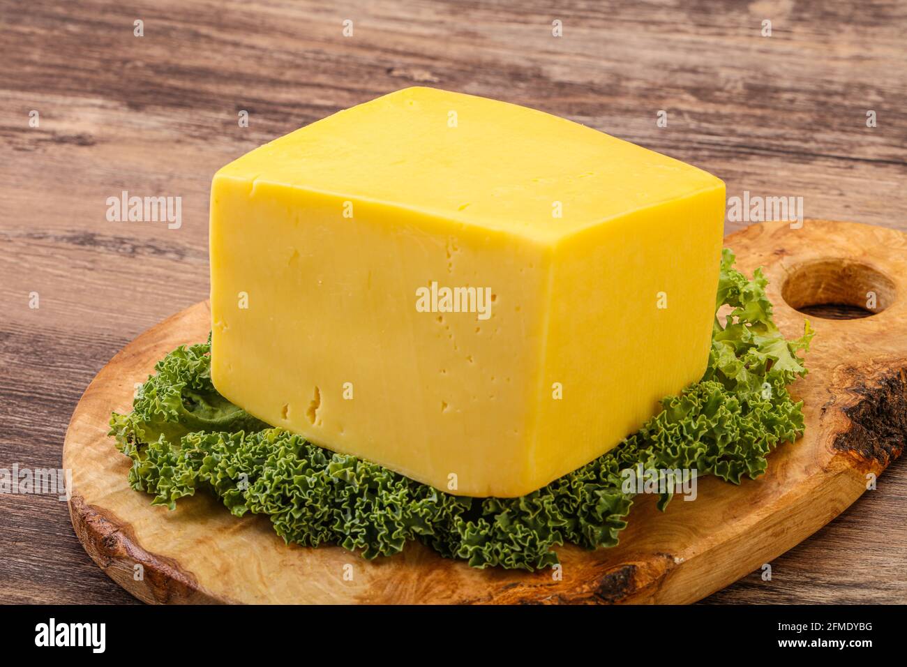 Yellow tilsiter cheese dairy product brick Stock Photo - Alamy