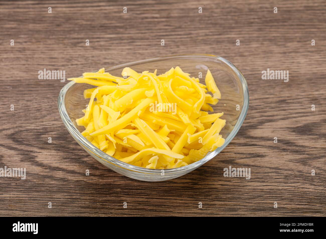 Shredded yellow cheese in the bowl for cooking Stock Photo - Alamy