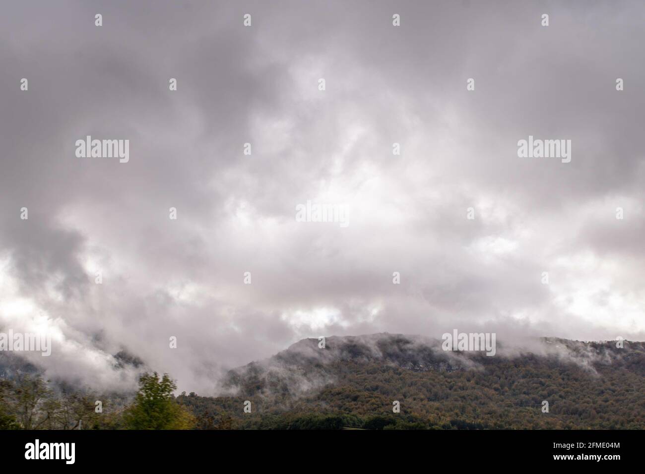 Cloudy heavy sky hanging on the mountains Stock Photo - Alamy