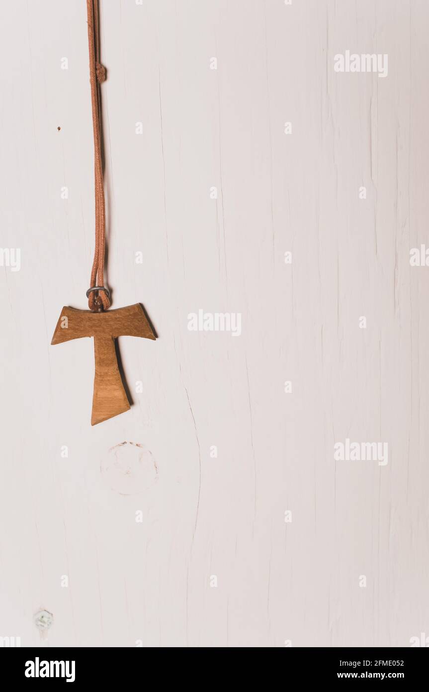 Vertical shot of wooden tau cross T-shaped necklace isolated on white ...