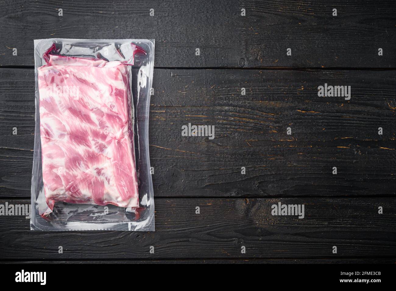 Sous vide vacuum pork rip food set, on black wooden table background ...