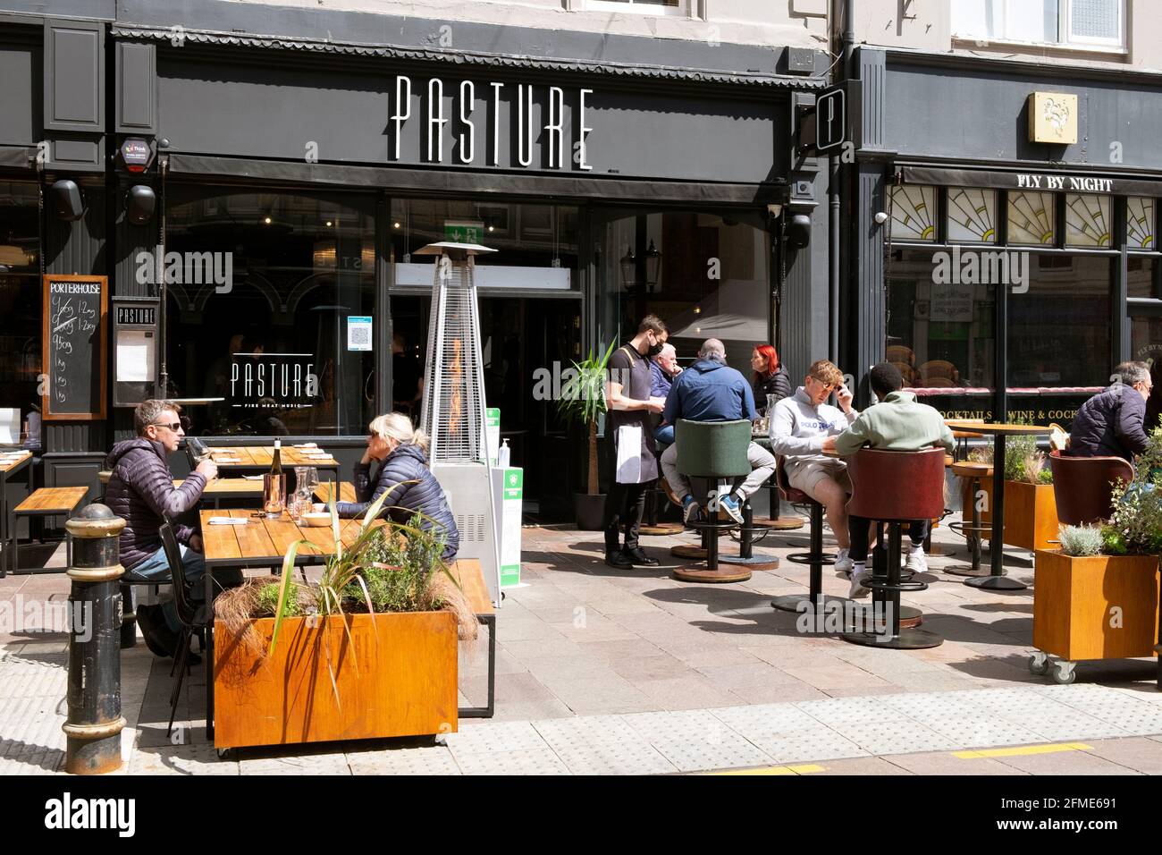 Exterior view of people customers sitting outside PASTURE restaurant in ...