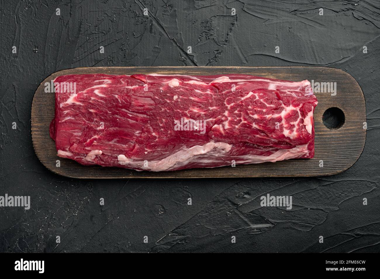 Raw beef meat set, on wooden cutting board, on black stone background ...