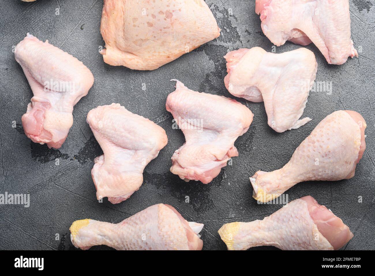 Raw chicken meat fillet, thigh, wings and legs set, on gray stone ...
