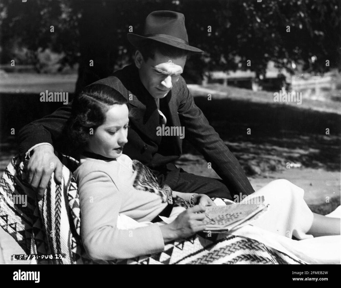 MERLE OBERON and LAURENCE OLIVIER on set candid in the grounds of Denham Studios during a break ...