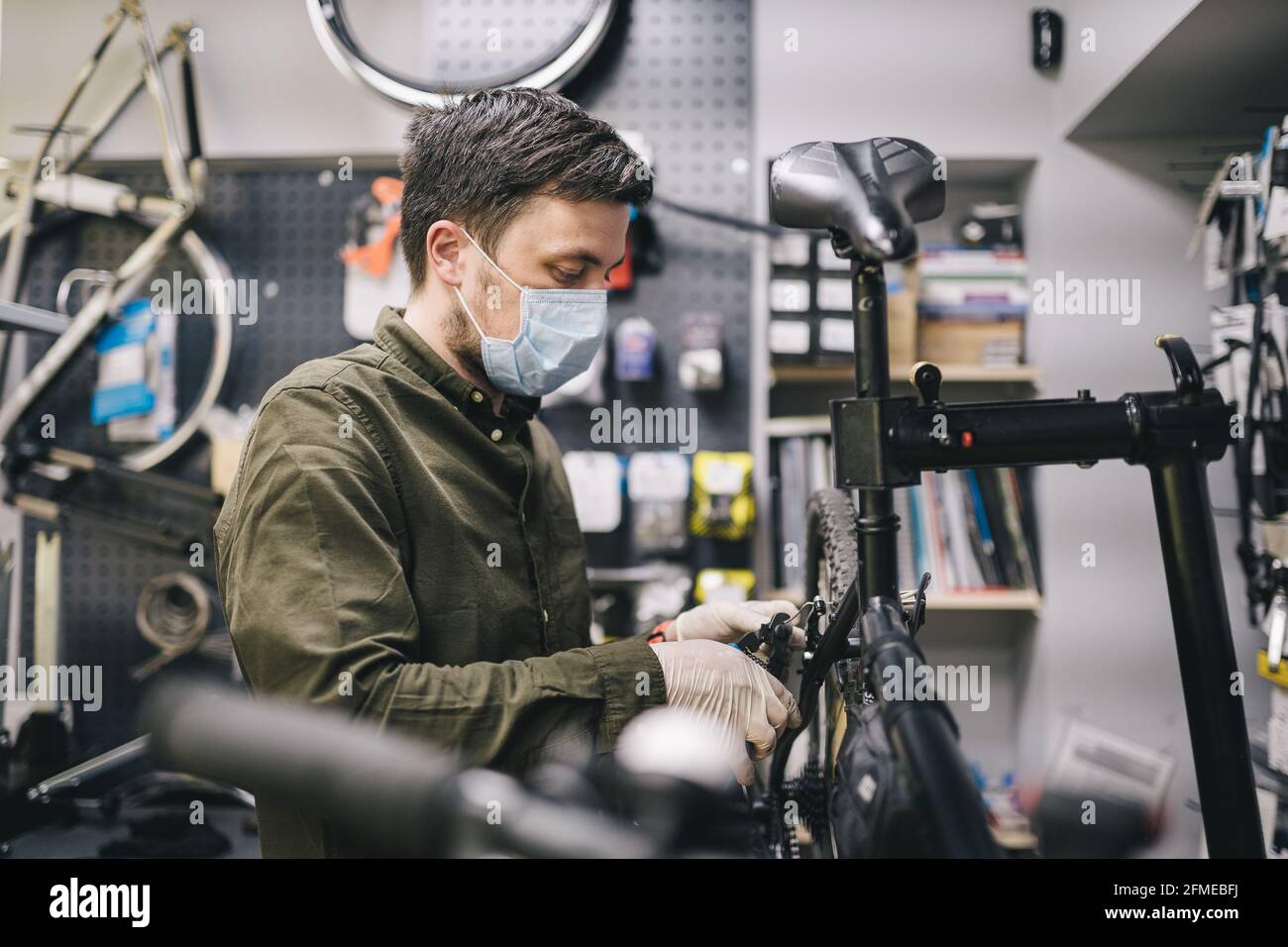 Bicycle shop repairman works in bicycle service and repair workshop ...