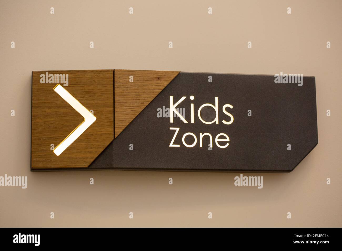 Closeup shot of a horizontal wooden guiding sign leading to the kids ...