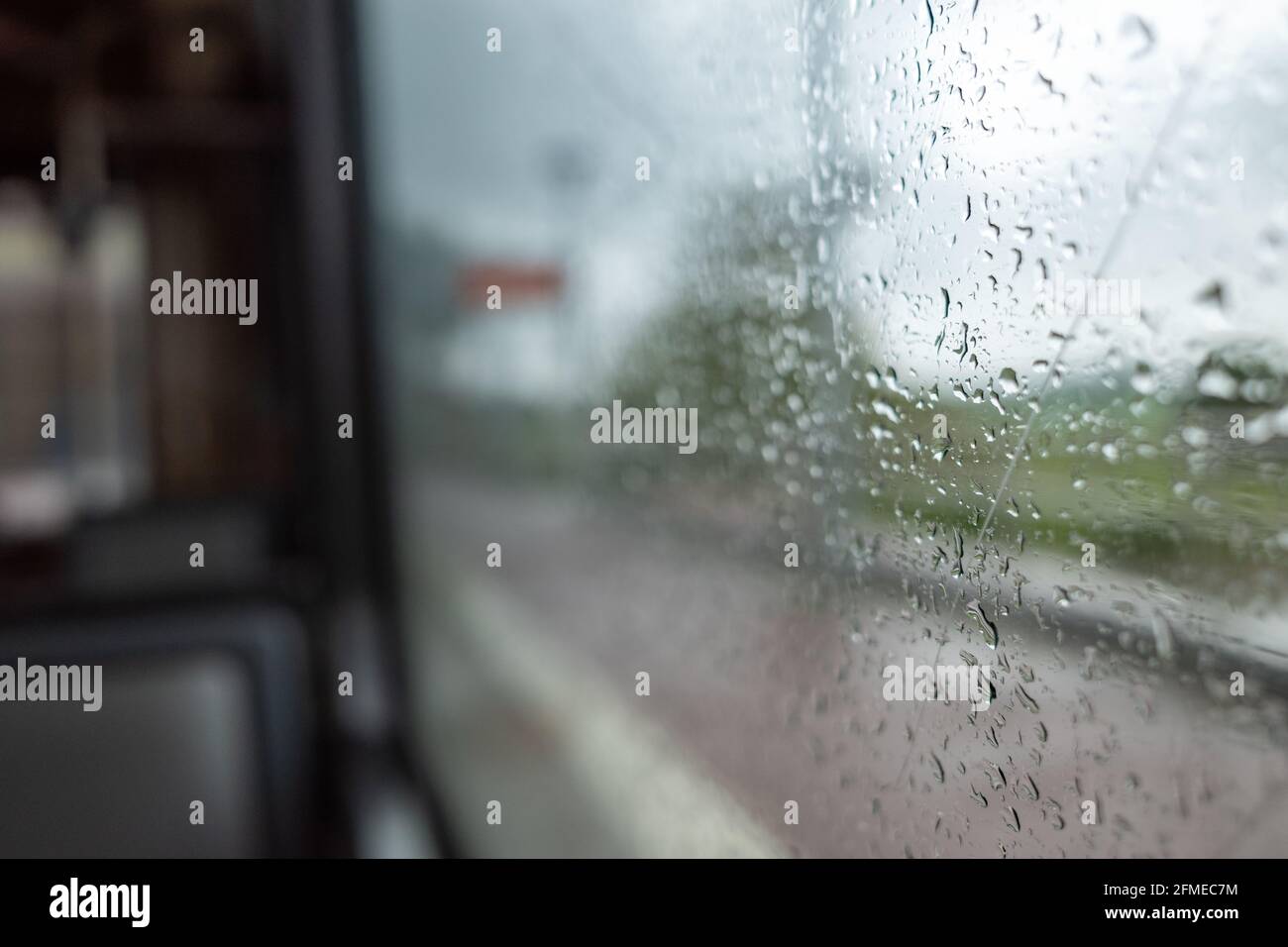 Close-up and macro view of raining water drop on outside windows of the ...