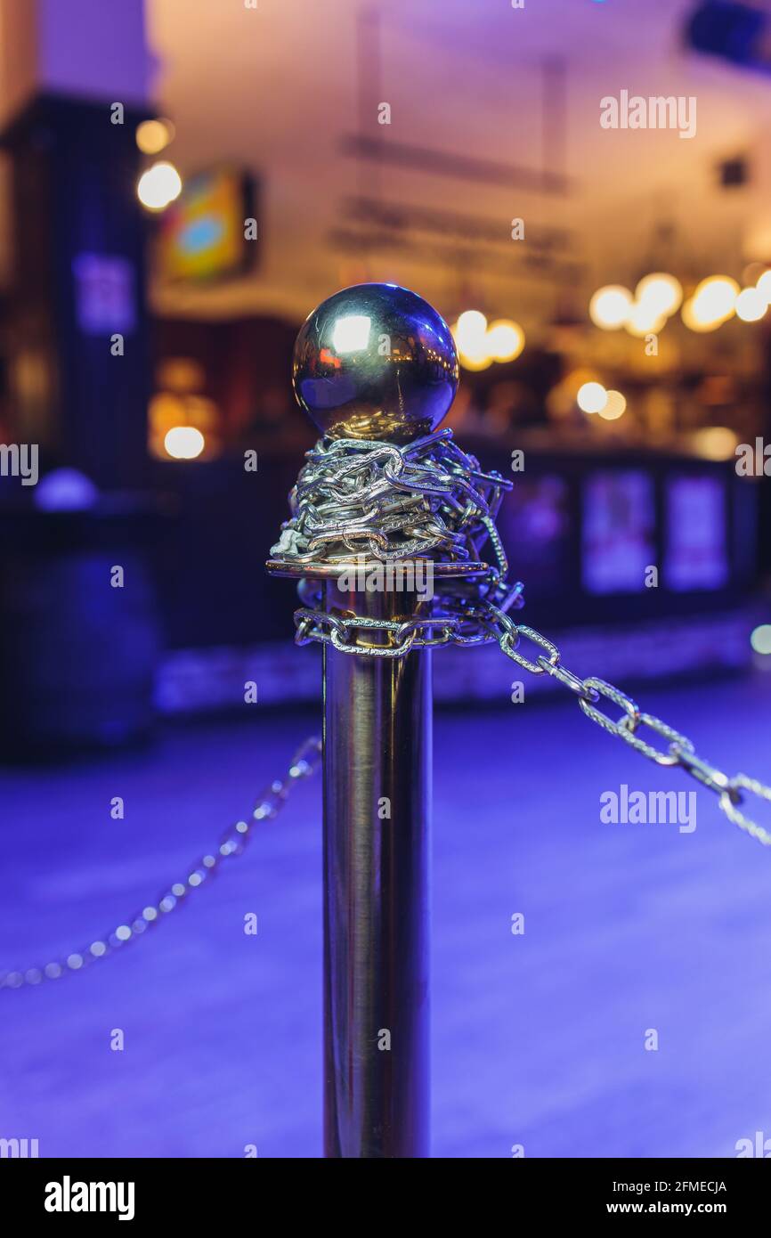 Chains dangling from poles for the delimitation of parking lots or ...