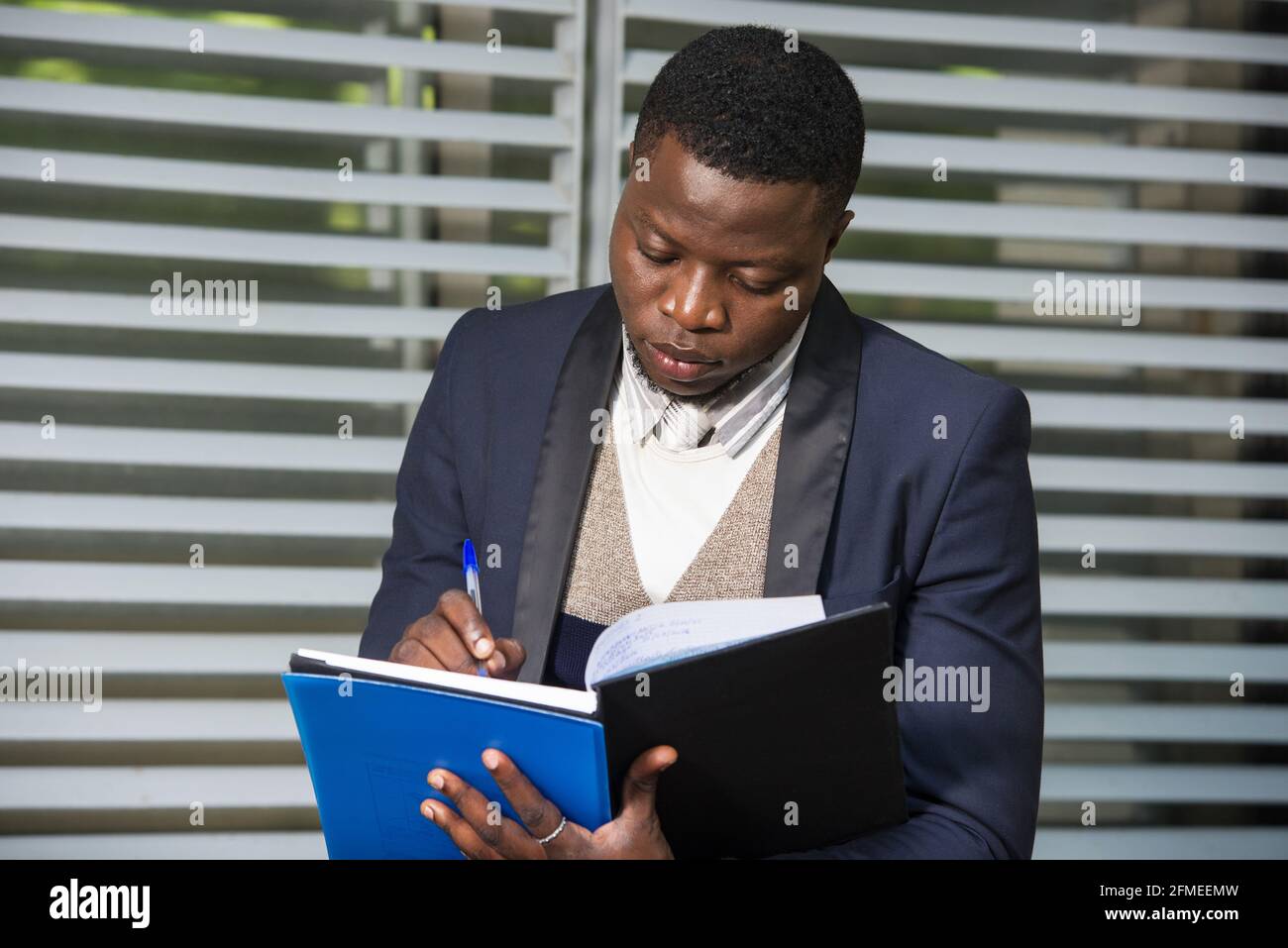 Portrait of businessman writing information on how to develop his ...