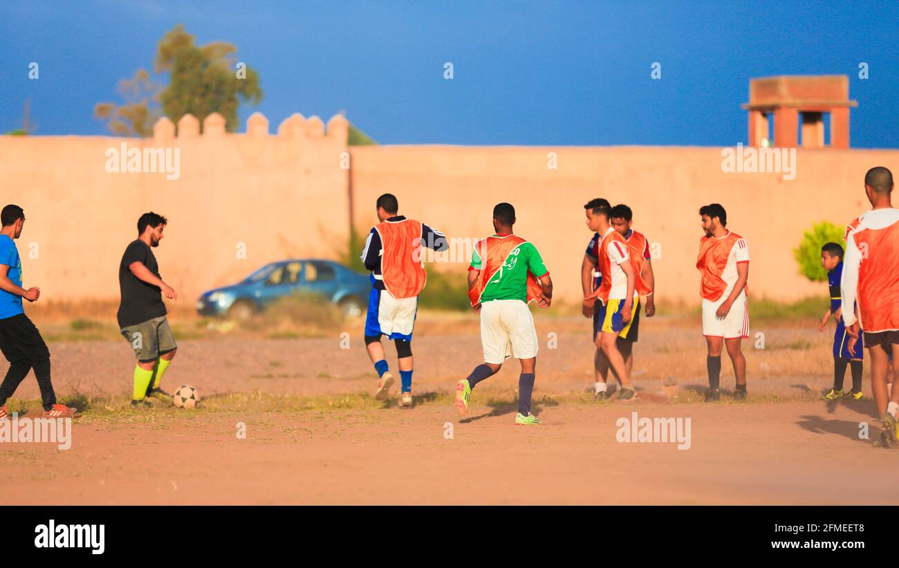 Marrakech, Morocco - 25 APRIL 2021 : Men playing football on a dusty ...