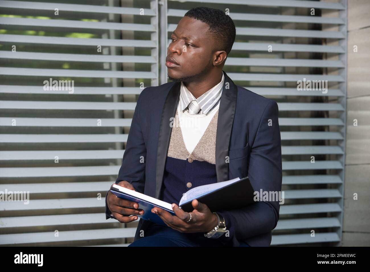 Portrait of businessman writing information on how to develop his ...
