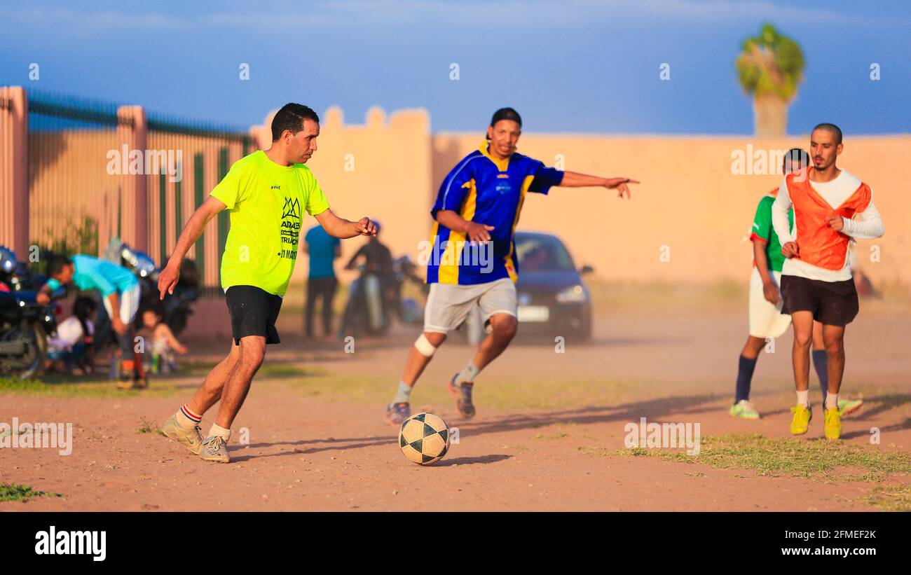 Marrakech, Morocco - 25 APRIL 2021 : Men playing football on a dusty ...