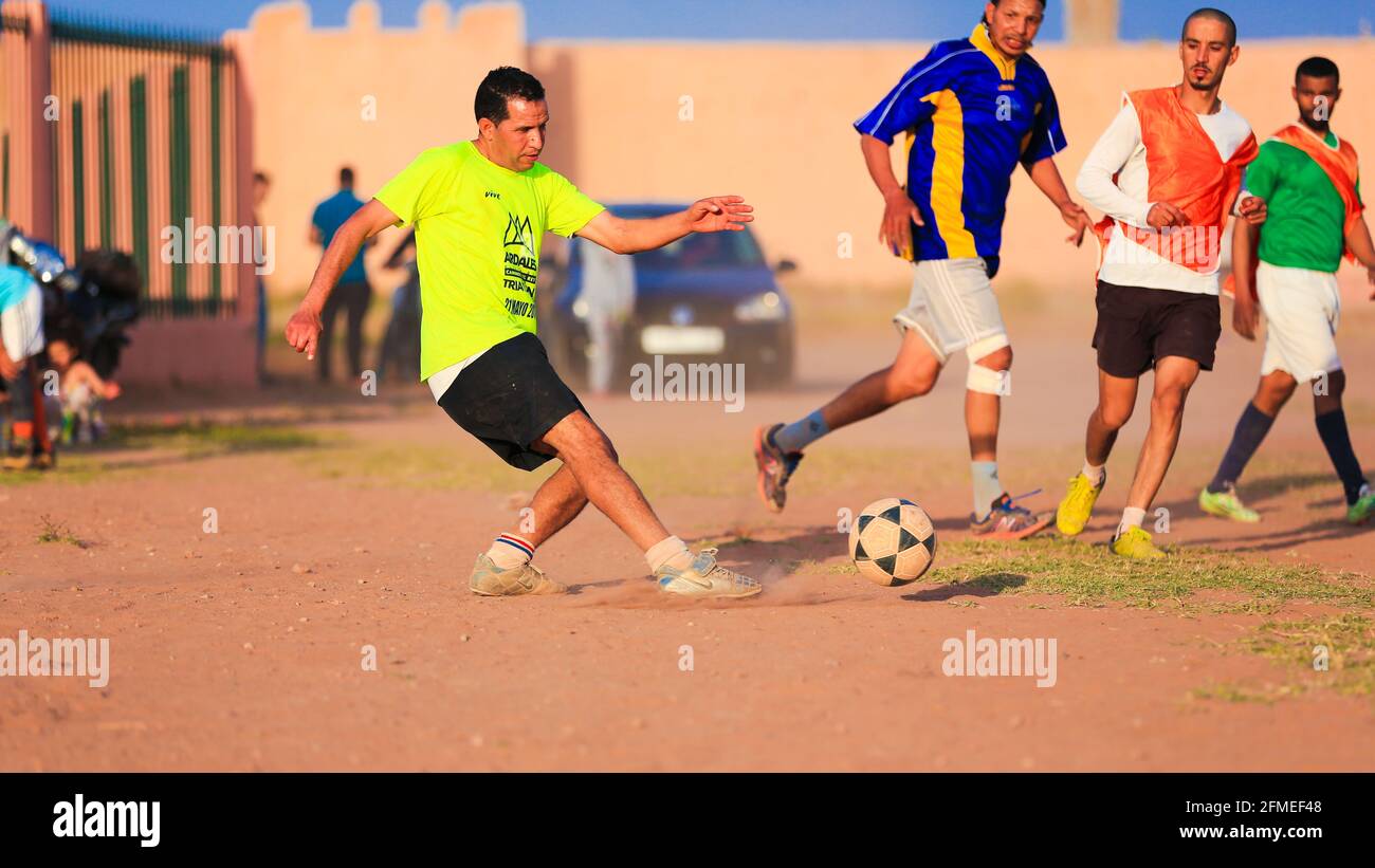 Marrakech, Morocco - 25 APRIL 2021 : Men playing football on a dusty ...