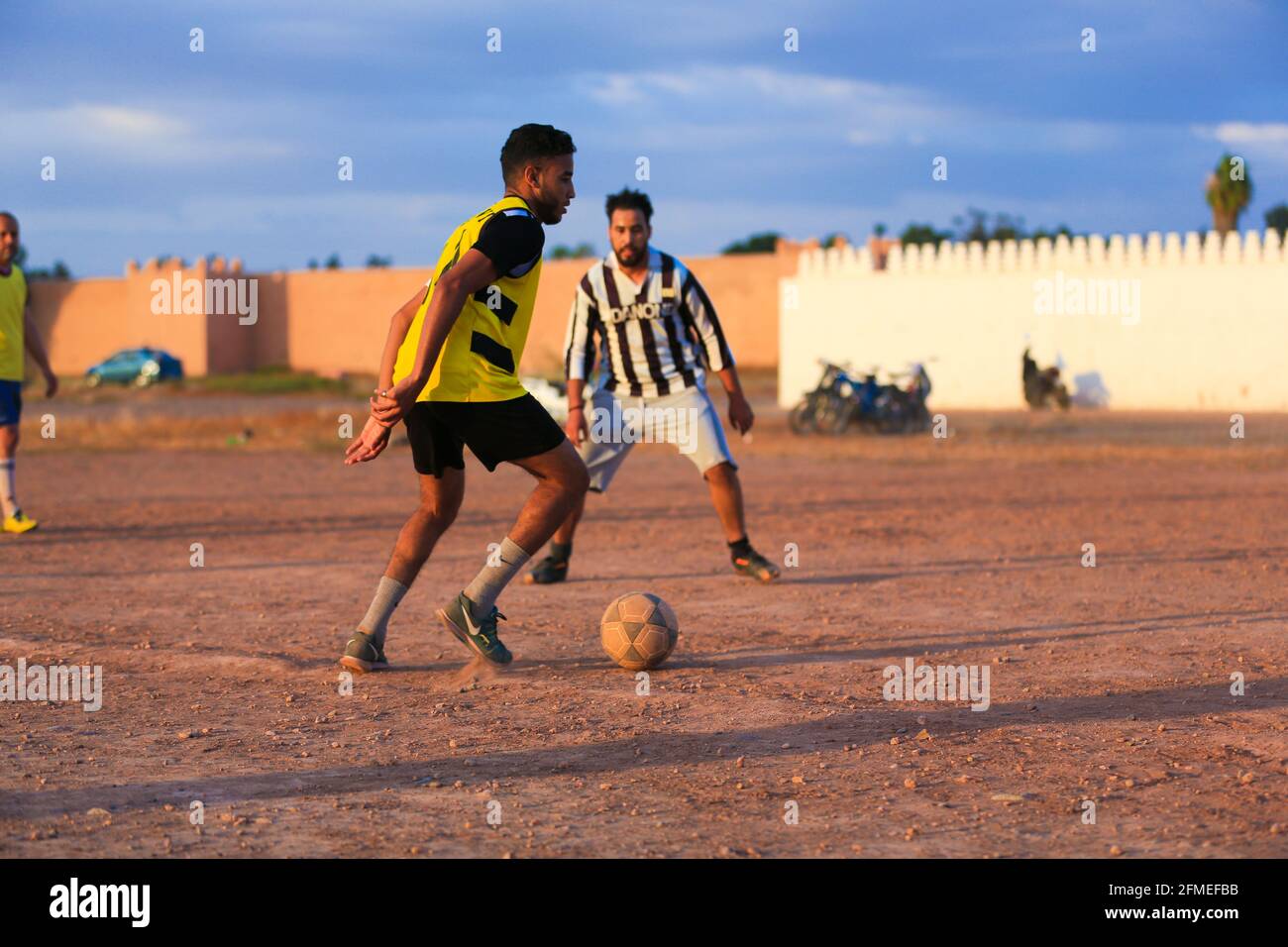 Marrakech, Morocco - 25 APRIL 2021 : Men playing football on a dusty ...