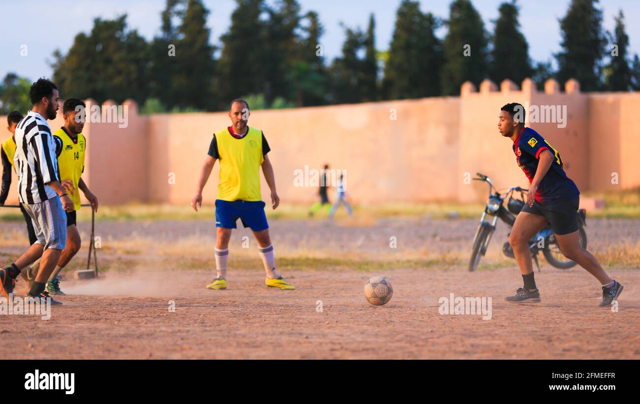 Marrakech, Morocco - 25 APRIL 2021 : Men playing football on a dusty ...