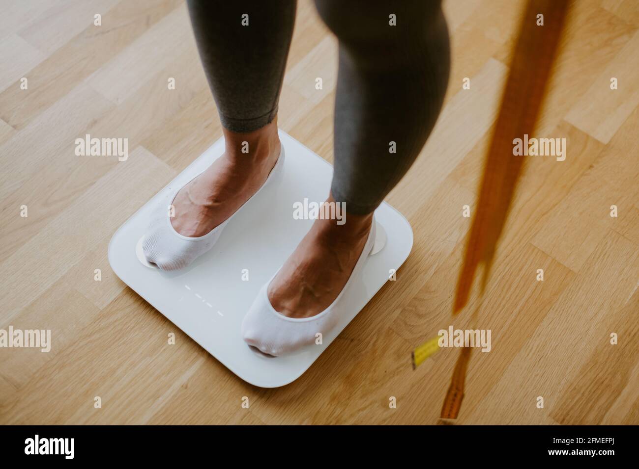 Woman Measuring Body Weight At Home. weight loss control Stock Photo ...