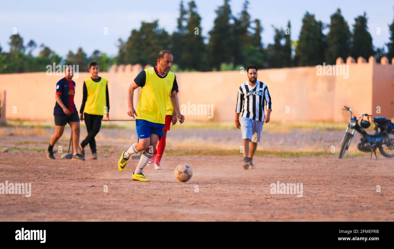Marrakech, Morocco - 25 APRIL 2021 : Men playing football on a dusty ...