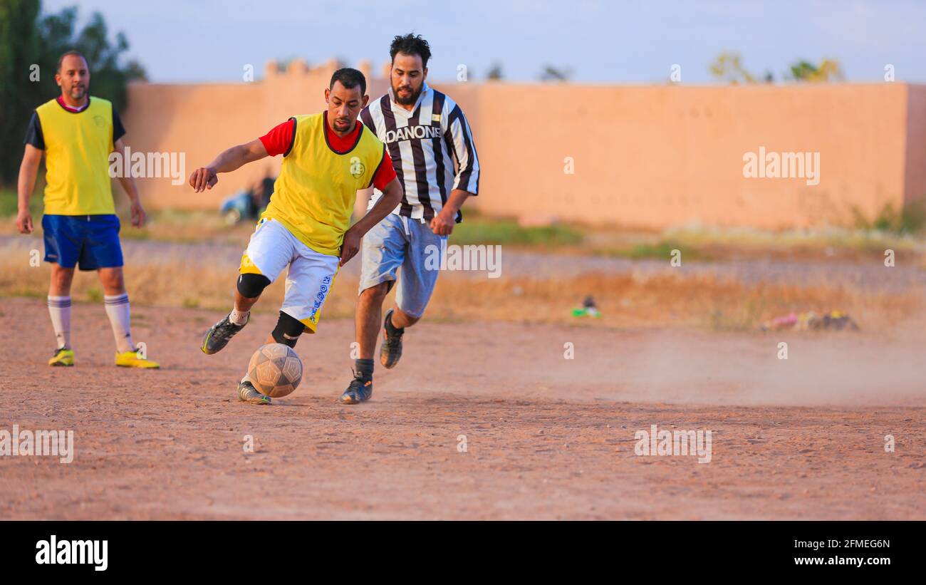 Marrakech, Morocco - 25 APRIL 2021 : Men playing football on a dusty ...