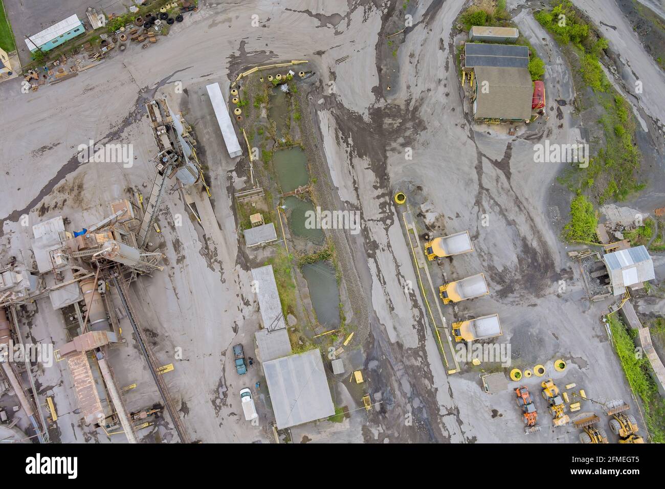 Aerial view from above of open cast mining quarry with machinery at ...