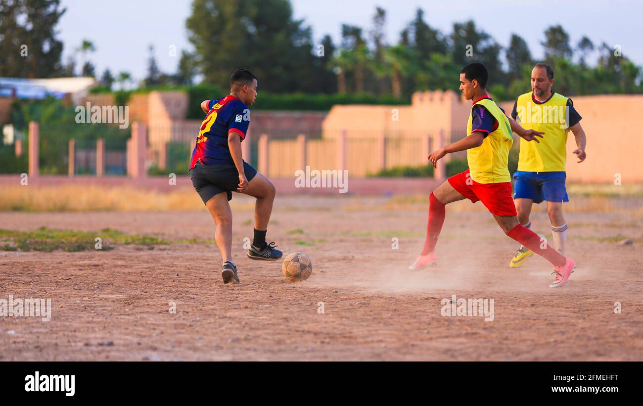 Marrakech, Morocco - 25 APRIL 2021 : Men playing football on a dusty ...