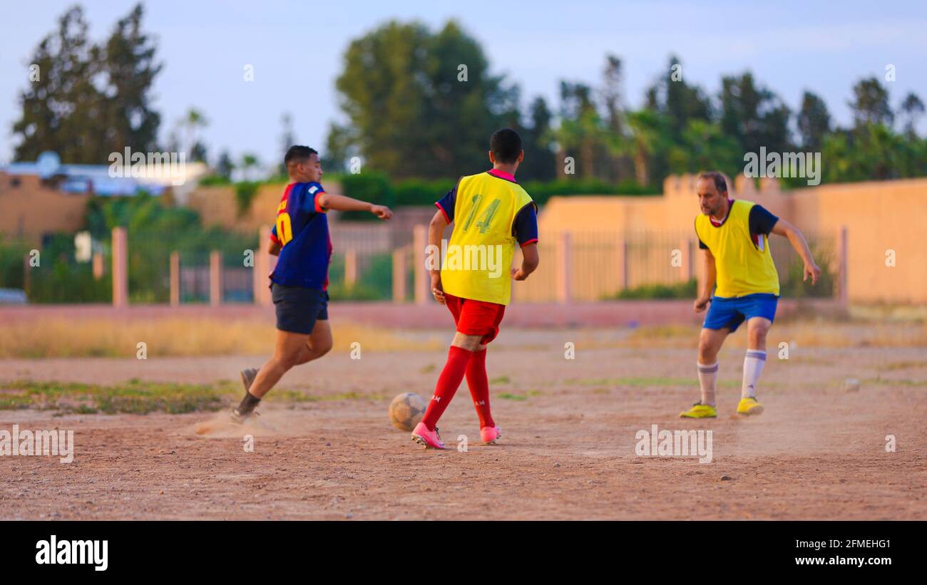 Marrakech, Morocco - 25 APRIL 2021 : Men playing football on a dusty ...